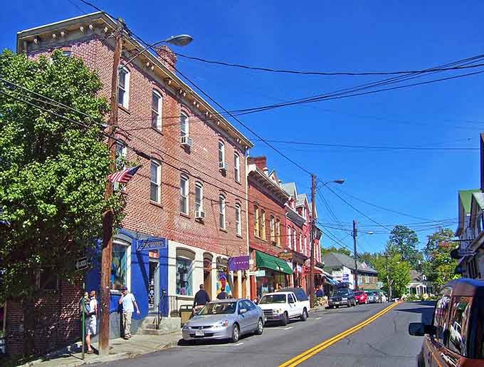 Brick row houses march up the hill in perfect formation, their colorful awnings saluting passersby with cheerful waves.