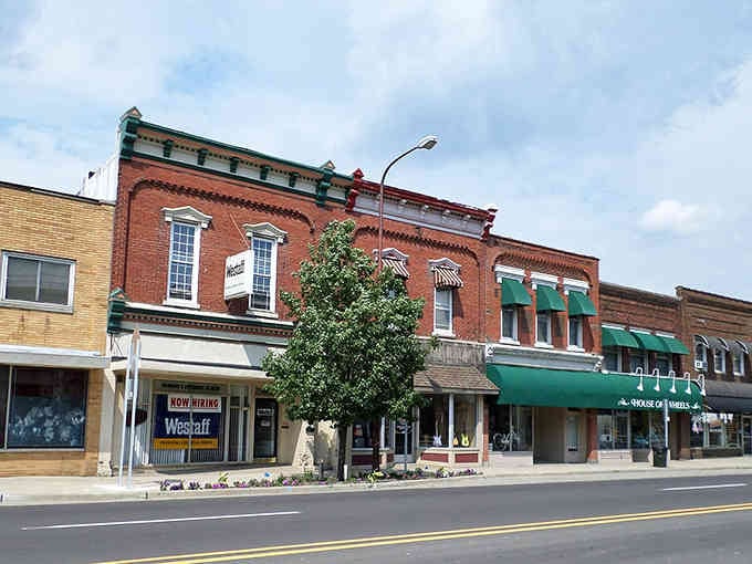 Ornate brickwork and green awnings add personality to storefronts that have weathered decades of economic ups and downs.