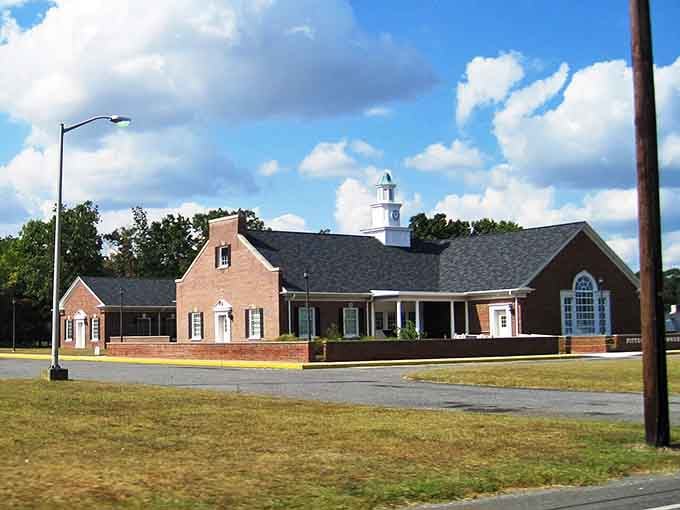 Red brick and white trim create the kind of municipal elegance that makes you want to vote just for fun.