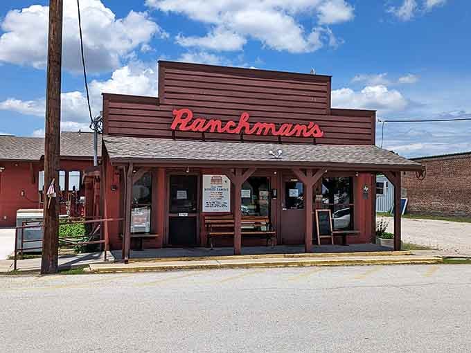 The red neon sign against brown siding creates a beacon for anyone craving honest-to-goodness home cooking.