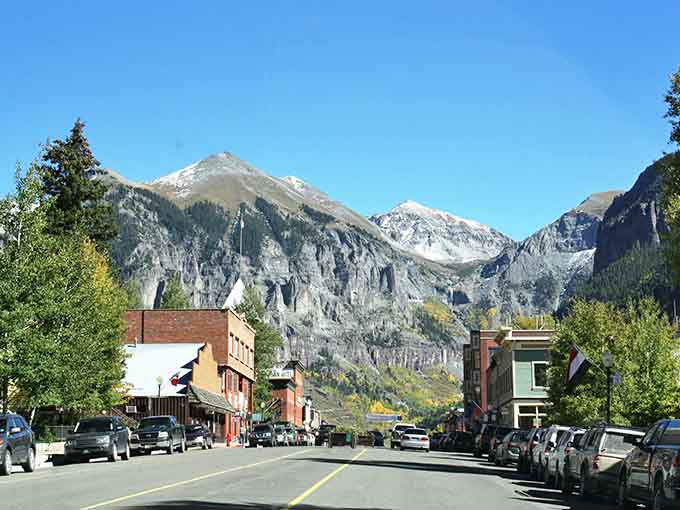 Main street frames those towering peaks like nature decided to photobomb this charming mountain town's portrait.