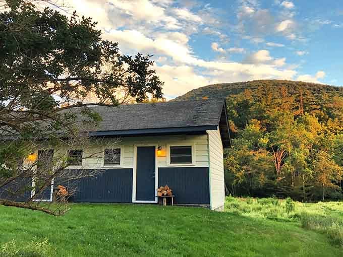 Golden hour bathes this simple cottage against autumn mountains, proving that sometimes less really is spectacularly, breathtakingly more.