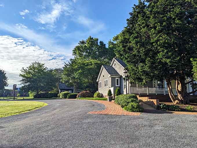 That brick pathway curves past a cottage that looks like it belongs in a fairy tale, complete with manicured gardens.