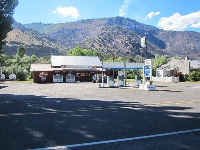 A gas station and convenience store sit beneath towering hills in a spot where filling up means more than just your tank.