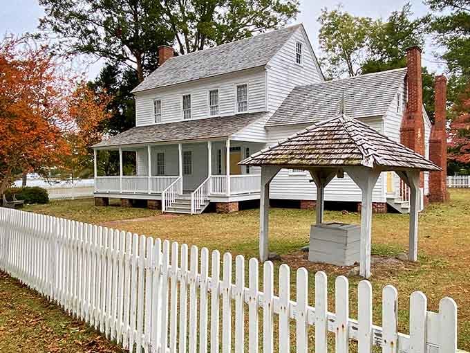 White clapboard and brick chimneys create a scene so authentic you can almost smell the wood smoke.