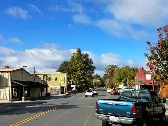 Small-town main street stretches toward the mountains, where pickup trucks outnumber luxury sedans by design.