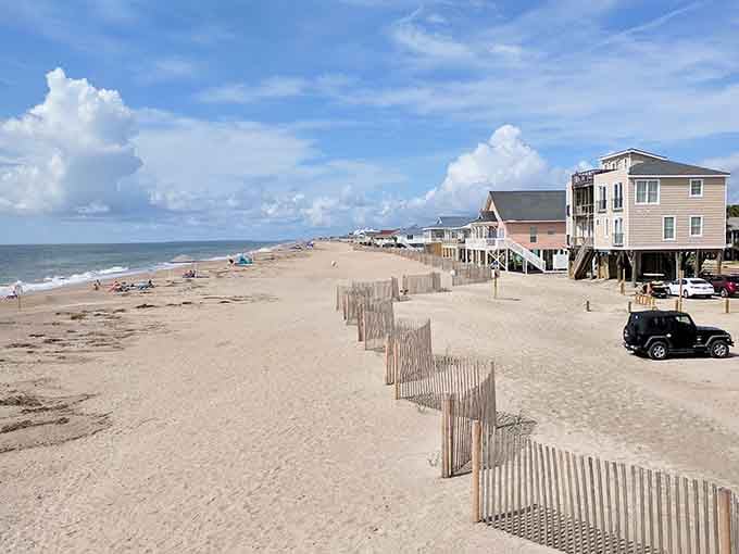 Wooden fences guide the way across pristine sand where footprints are the only interruption for miles.
