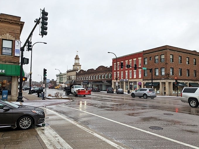 Rain-slicked streets reflect the ornate clock tower, proving that even gray days can't diminish this downtown's architectural magnificence.