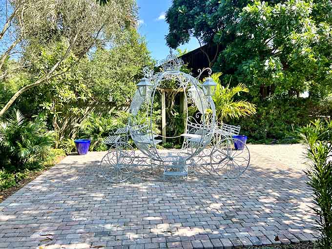 A Cinderella carriage sits ready among brick pathways and tropical blooms for your fairy tale moment.