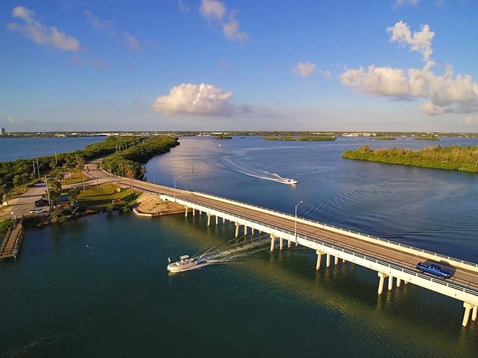 From this height, you can see boats cutting white wakes through blue water like zippers opening the sea.