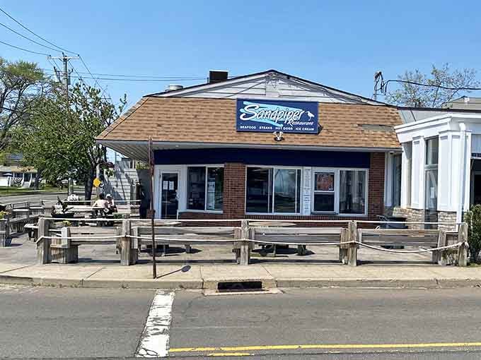 The casual outdoor seating at Sandpiper invites you to grab seafood and soak up the shore atmosphere.