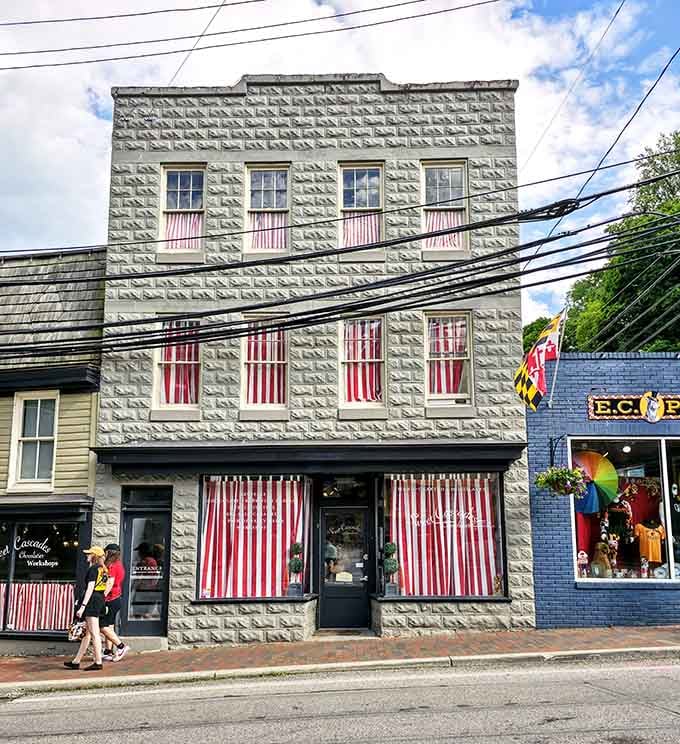 The historic stone facade and candy-striped awnings make this corner shop look like it stepped from a storybook.