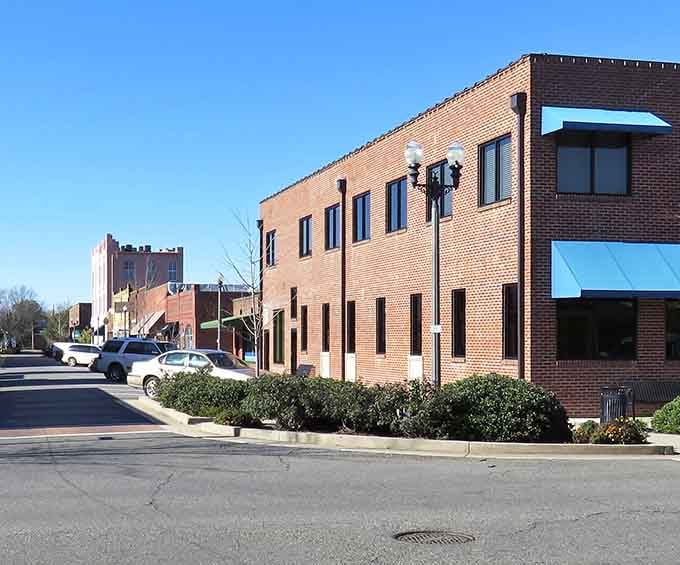 Clean brick lines and wide windows define this modern downtown building where small-town business meets contemporary Southern style.