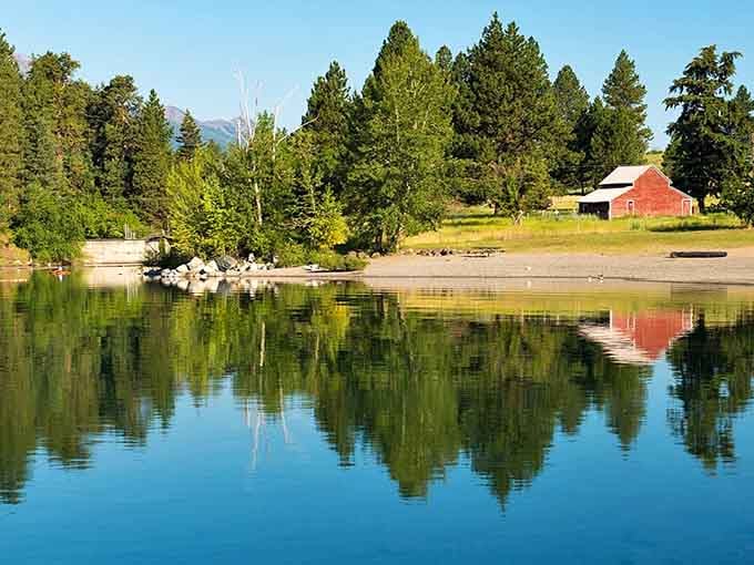 The red barn's reflection doubles the charm in water so still it could be polished glass on a windless day.