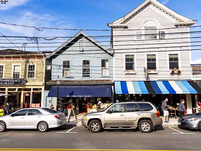 Colorful awnings and beautifully preserved storefronts create an inviting atmosphere where every building tells a story of Chester's rich maritime history.