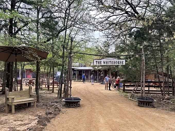 The Whitehorse beckons through the trees like a rustic oasis where steak dreams come true.