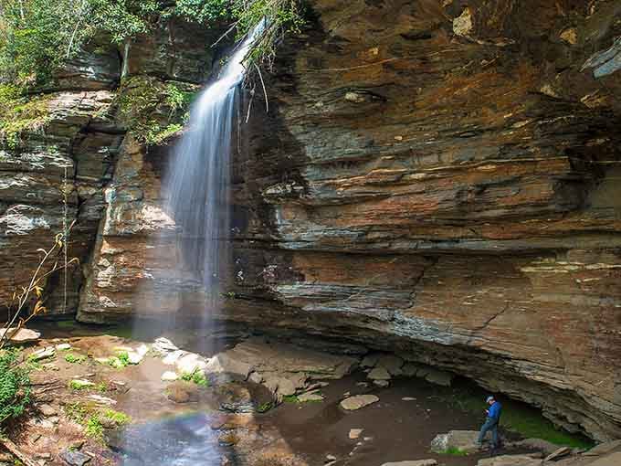 Water cascading over ancient layered rock like nature's own theatrical curtain call, complete with a standing ovation.