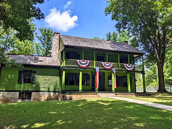 That bright green exterior with patriotic bunting isn't just charming, it's a full-on history hug waiting to happen.