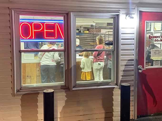 That glowing red OPEN sign at night is like a lighthouse guiding hungry souls to salvation.