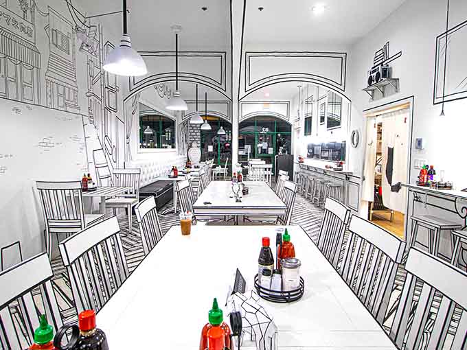 Long communal tables with bold black outlines invite you to sit down and enjoy authentic Vietnamese cuisine in cartoon style.