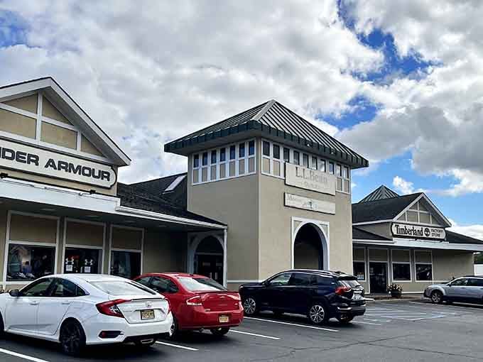 That classic outlet mall architecture hints at savings inside, set in a scenic landscape where shopping meets natural beauty.