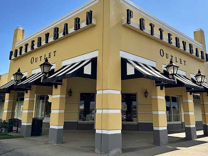 That cheerful yellow facade with black-and-white striped awnings practically screams "come spend money and feel good about it!"