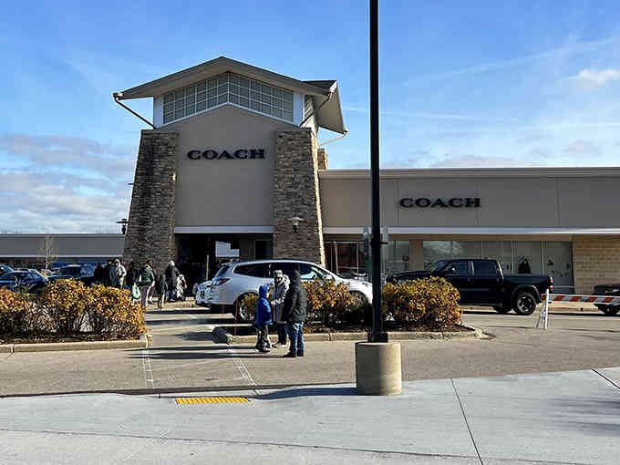 The Coach outlet draws shoppers like moths to a flame, promising luxury leather goods without the luxury guilt.