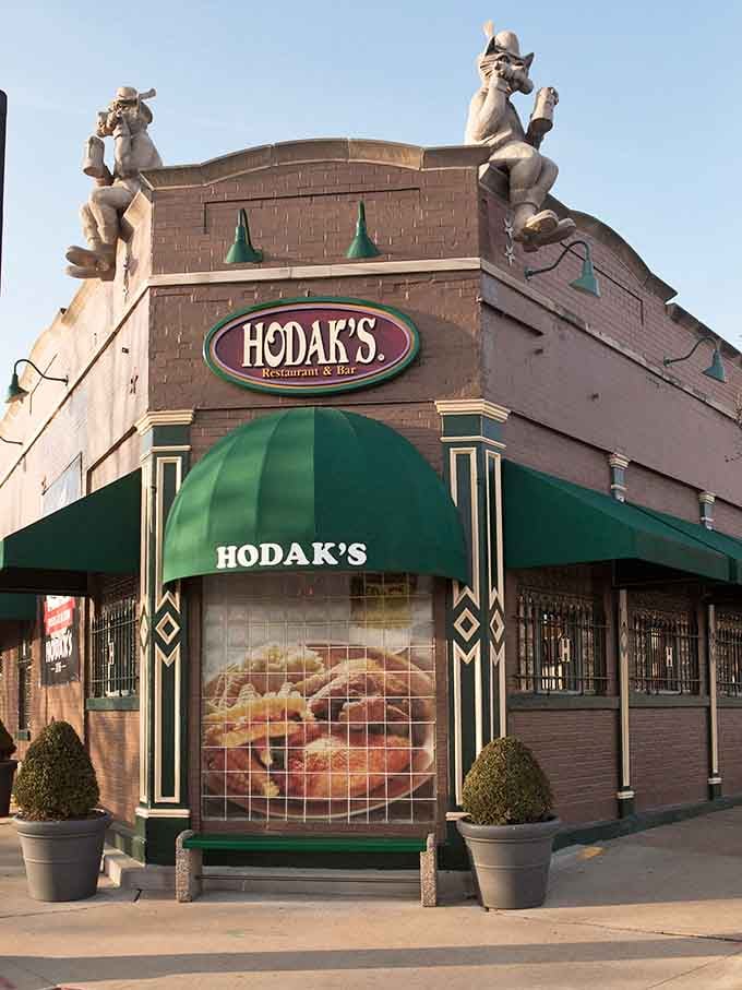 Rooftop statues, a green awning, and golden fried chicken in the window — Hodak's exterior announces itself like a headliner taking the stage.