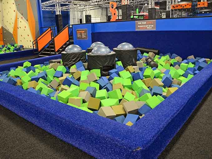 Dive into ultimate fun with this giant, colorful foam pit featuring soft cubes and exciting obstacles for everyone to enjoy!