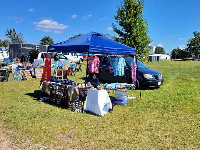 Under a brilliant blue sky, this vendor booth proves that art, hot sauce, and tie-dye truly belong together.
