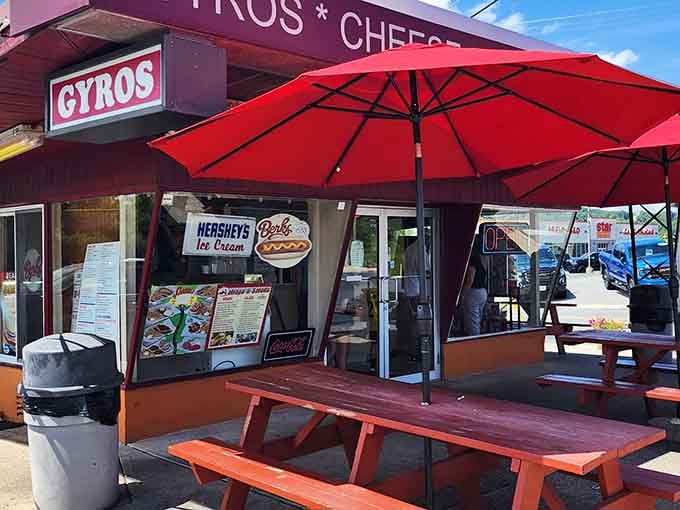Those red umbrellas aren't just shade, they're a beacon calling hungry travelers home to Vassi's Drive-In.