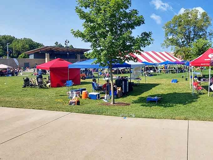 Colorful vendor tents dot the green space, creating a festive outdoor marketplace perfect for a beautiful Saturday morning shopping adventure.