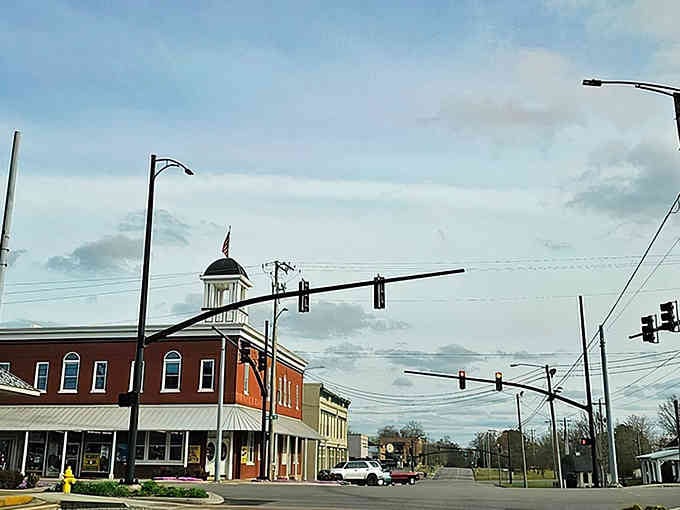 That charming cupola rising above downtown storefronts proves small-town architecture still knows how to make an entrance.