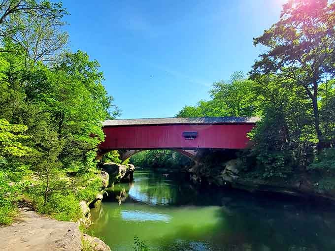 That red covered bridge against emerald Sugar Creek water is basically Indiana showing off without apology.