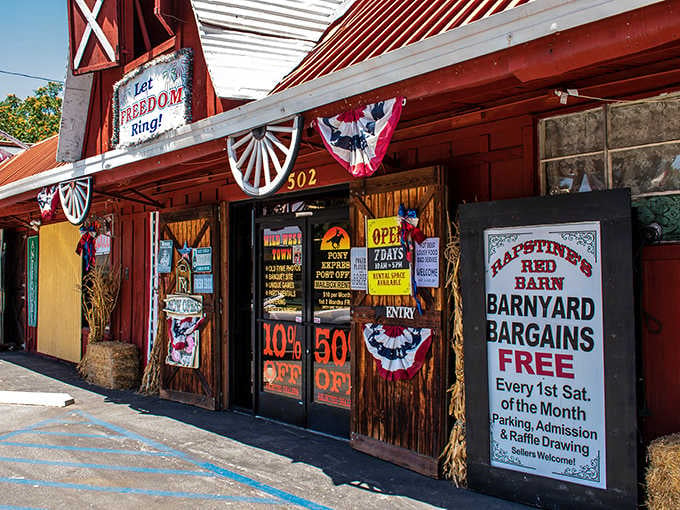 That bold red barn facade, patriotic bunting, and hay bales out front are basically the universe saying, "Stop the car."