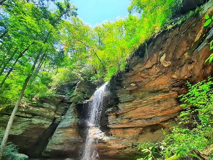 Water cascading over ancient layered rock like nature's own theatrical curtain call, complete with a standing ovation.