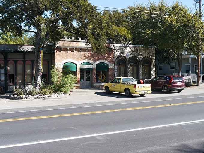 Old brick storefronts shaded by ancient oaks &mdash; Salado's main street looks exactly like America should feel.