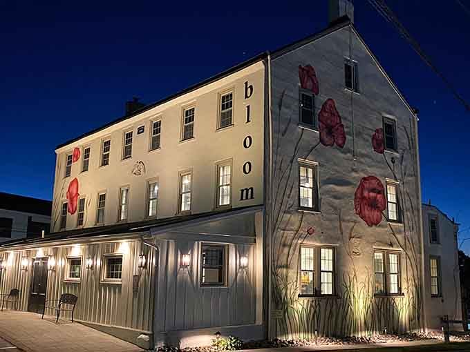 A cream-colored building with painted flowers and warm lighting. Chester Springs clearly has excellent taste.