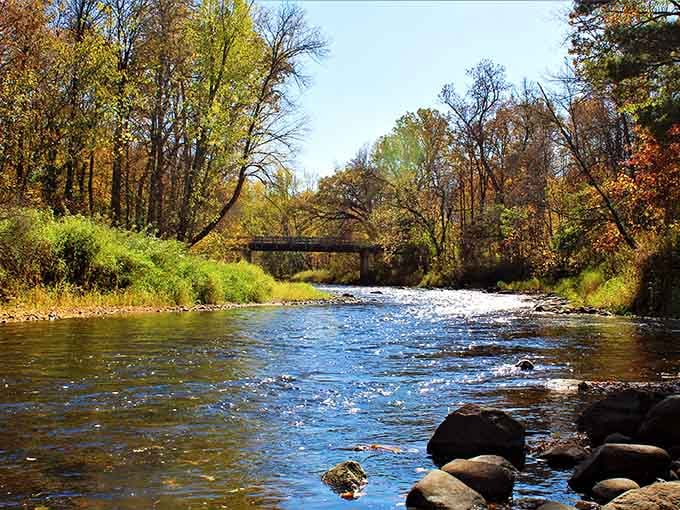 Autumn turns this rocky riverscape into a living painting, where golden trees and sparkling water compete for your attention.
