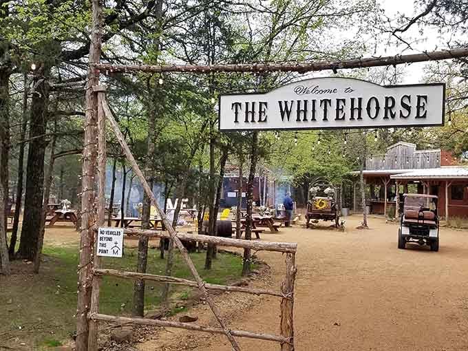 The Whitehorse beckons through the trees like a rustic oasis where steak dreams come true.