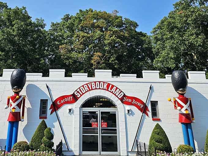Two giant toy soldiers stand guard at Storybook Land's castle entrance, daring you to stay grown-up inside.