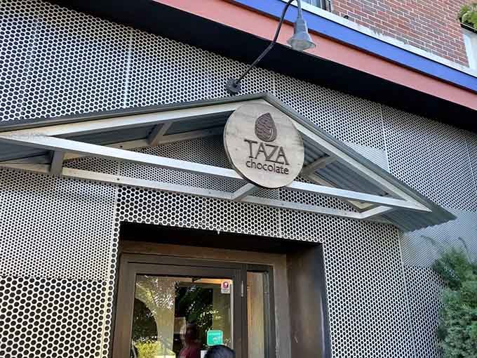 That round wooden sign overhead is your official invitation to the best-smelling building in Somerville.