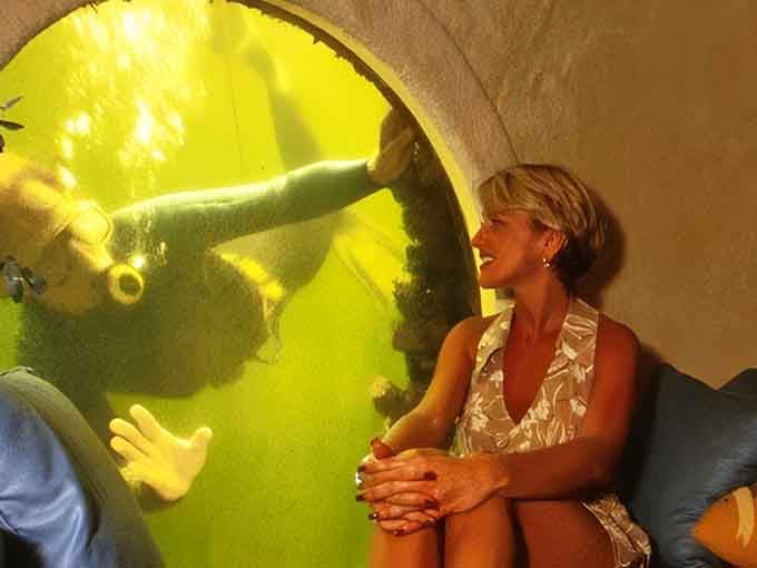 Your neighbors might wave through windows, but at Jules' Undersea Lodge, divers wave hello through your bedroom porthole instead!