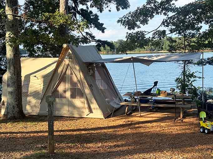 Set up the perfect canvas tent campsite right by the water's edge for a cozy, relaxing lakeside outdoor adventure.