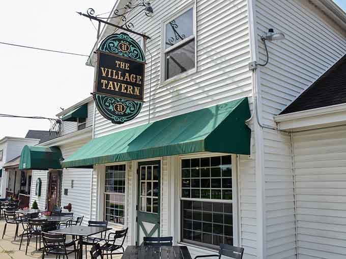 That ornate hanging sign beckons like a lighthouse for the hungry, promising comfort food and good times within those historic walls.