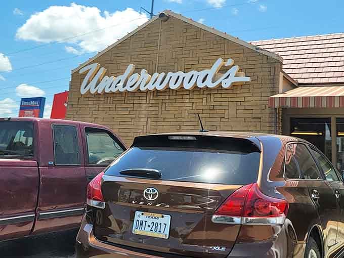 A humble stone exterior with a striped awning, proof that the best meals never need to show off.