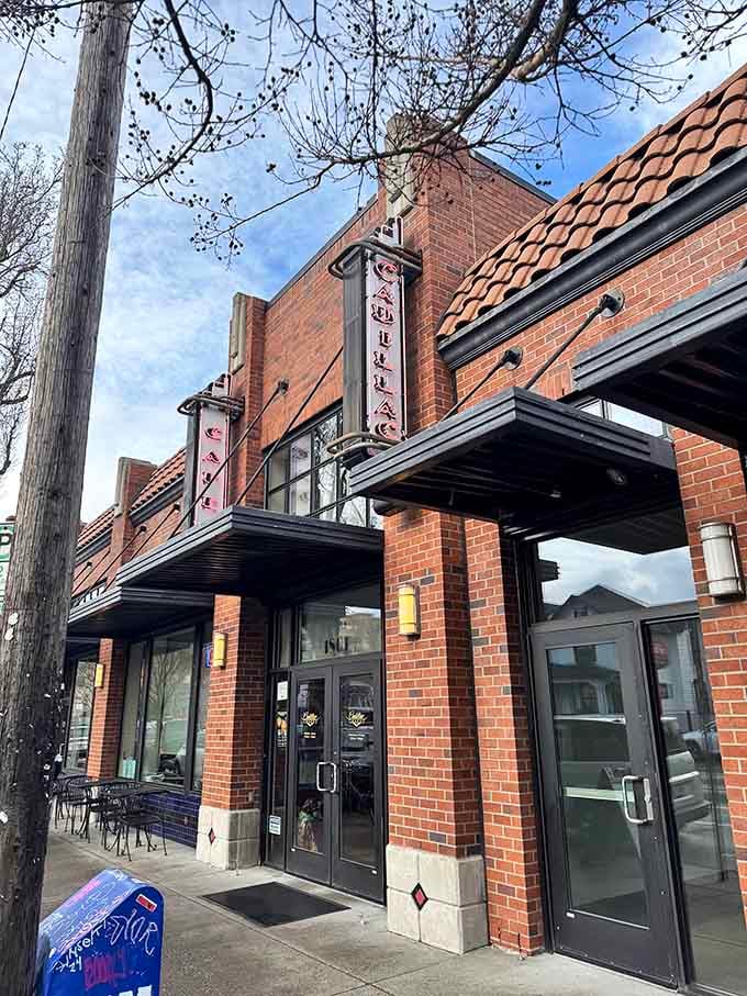The classic brick exterior and vintage signage of Cadillac Cafe blend perfectly into Portland's charming neighborhood streetscape and welcoming atmosphere.