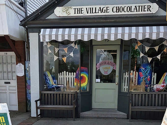 That charming awning and storefront practically whisper "come inside" louder than your sweet tooth already is.