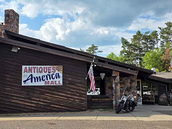 A motorcycle parked out front, an American flag flying proud. Antiques America Mall means business, and it looks good doing it.