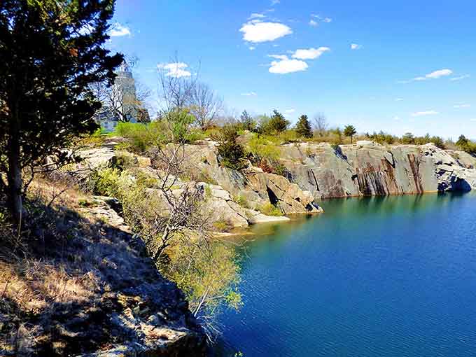 That otherworldly blue-green water filling the old granite quarry looks like something from a fantasy novel come to life.